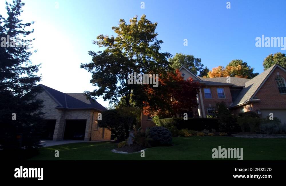 Driving Past High End Luxury Homes Sideview With Rays Of Sunlight Stock ...