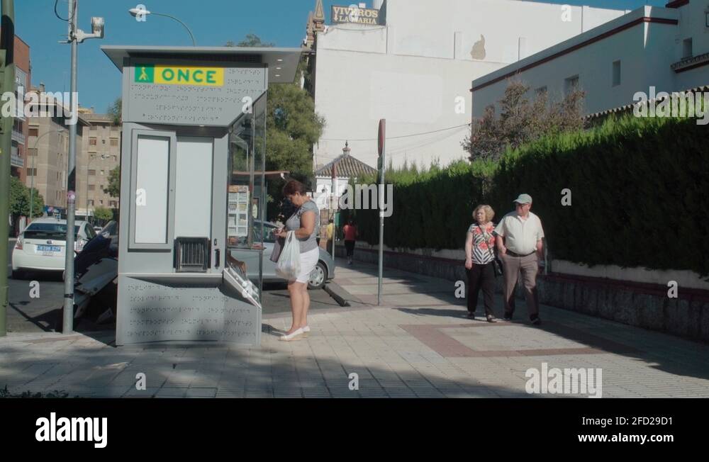 Woman buying fundraising lottery ticket from ONCE kiosk in Spain Stock ...