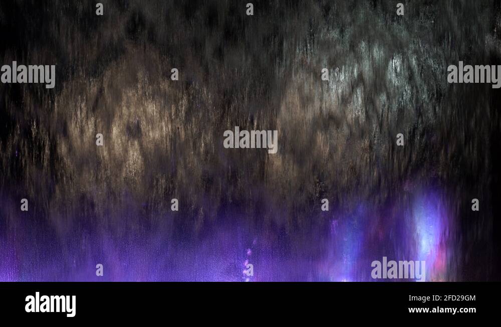 Colorful night water texture of fountain with blur lights and ...