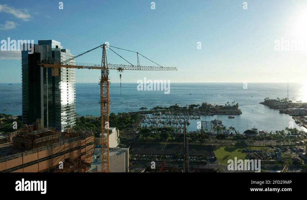 flying counter clockwise around a construction crane in downtown Honolulu Stock Video Footage ...