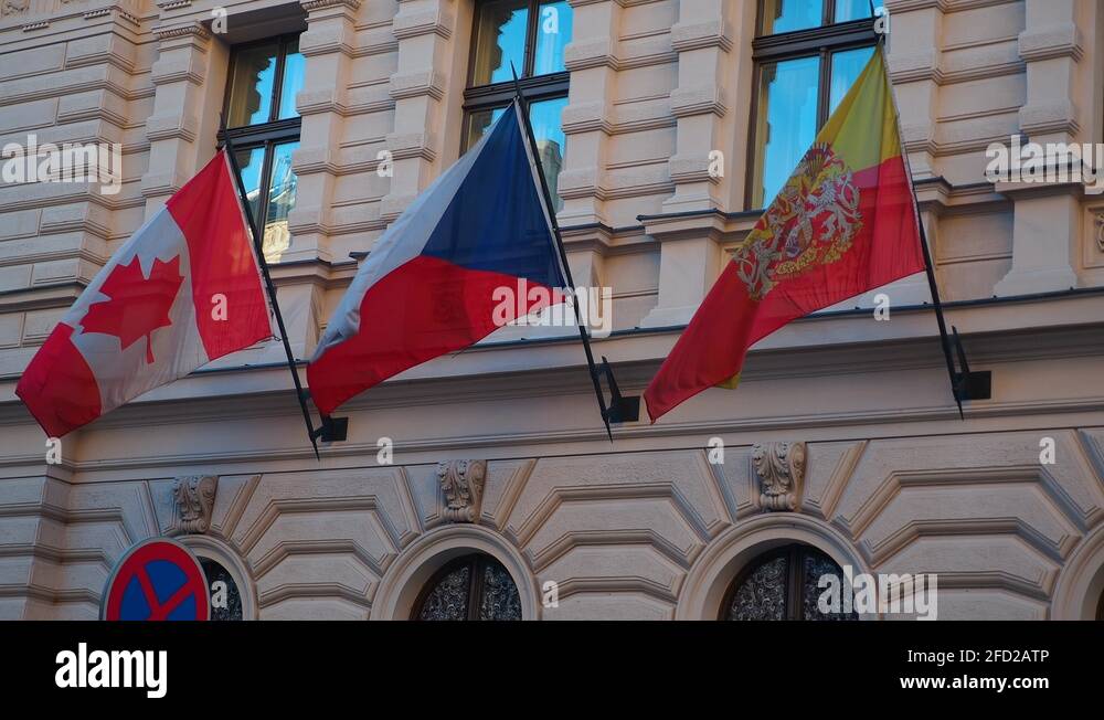 Wind blowing and waving the national flags of Czech Republic and Canada ...