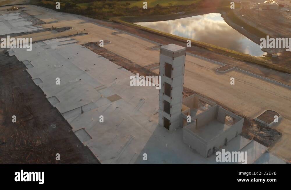 Orbiting view of a massive construction site and structural concrete ...