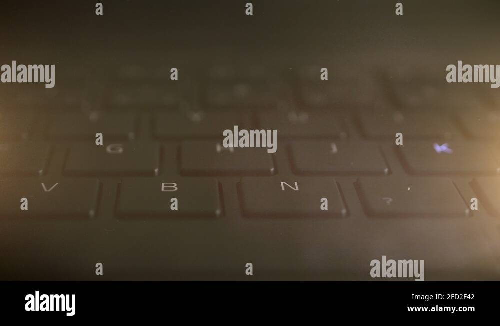 illuminated keyboard buttons letters in multiple RGB colors on modern ...