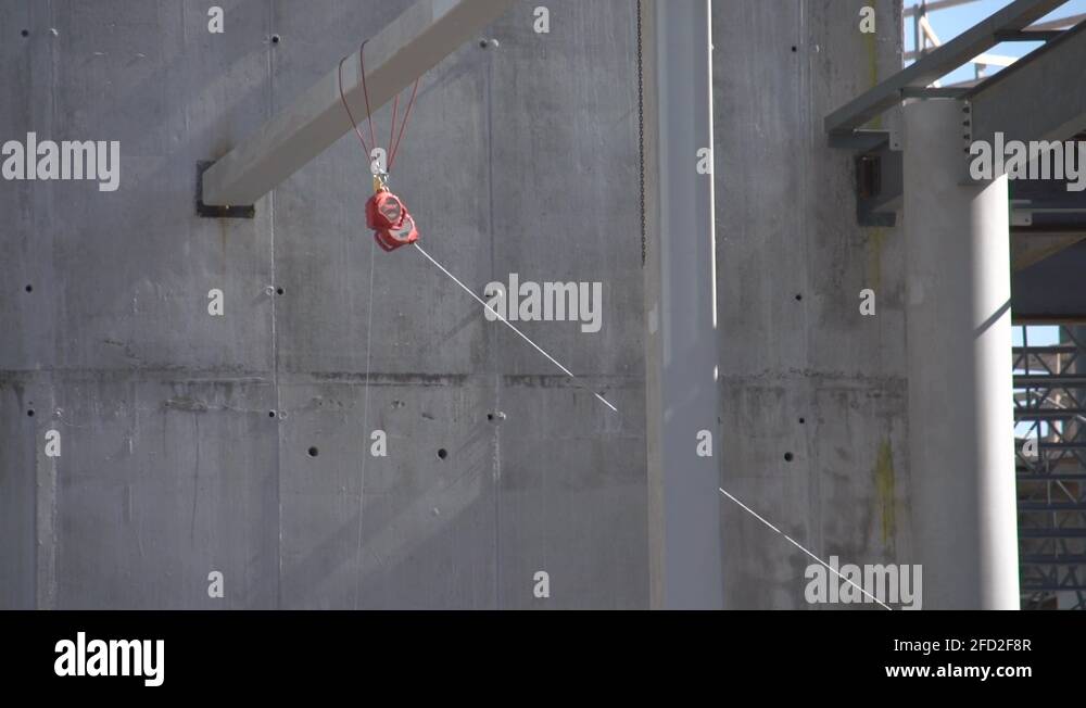 construction workers with safety rigging, tilt reveal Stock Video ...