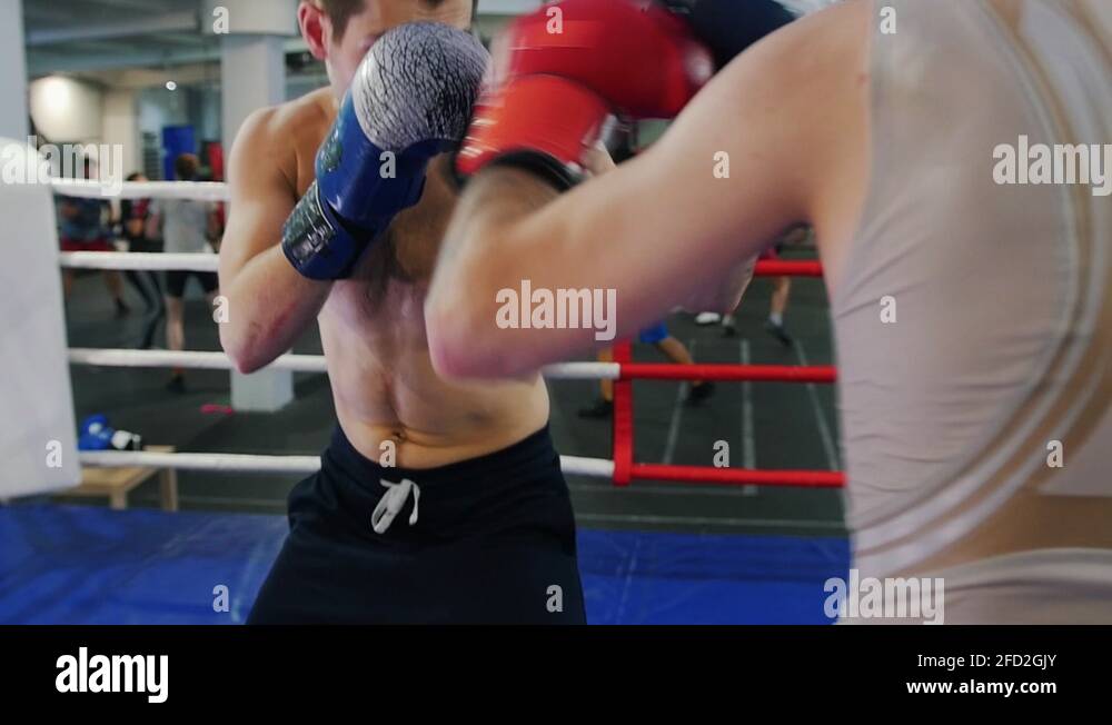Boxing indoors - two men having a fight on the boxing ring - attack and ...
