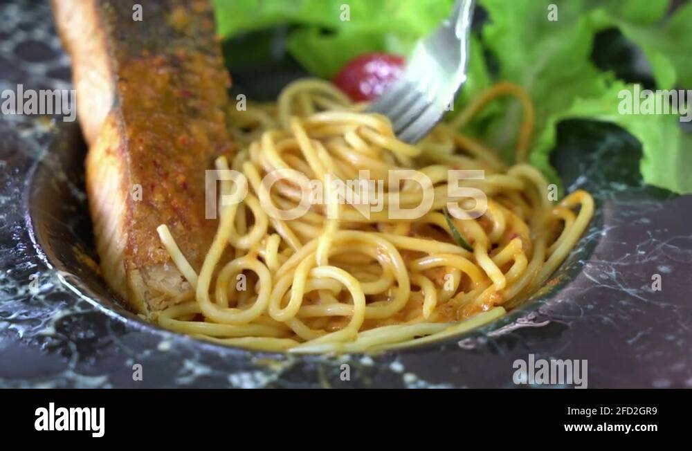 spaghetti with fried fish fillet and spicy sauce Stock Video Footage ...