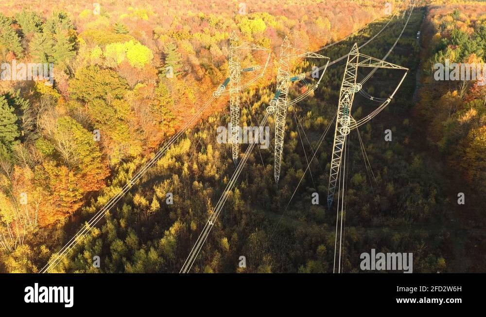 Electricity pylon viewed from drone flying low above it during pretty ...