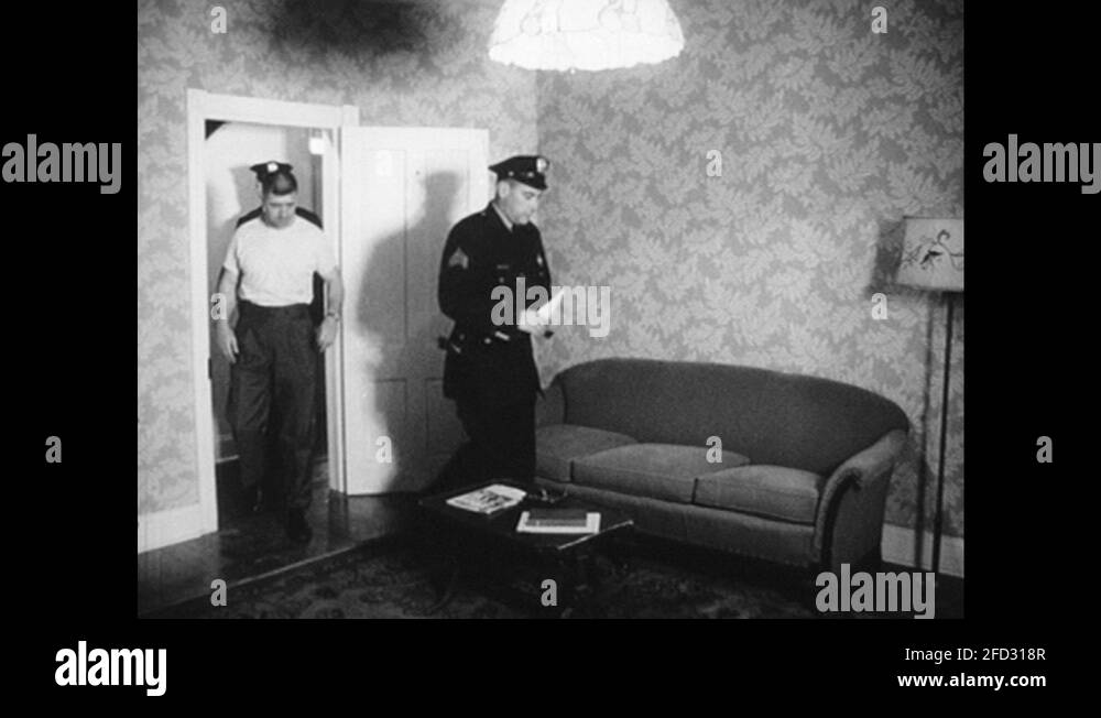 1960s: House, living room, police officers walk in, move sofa, man ...