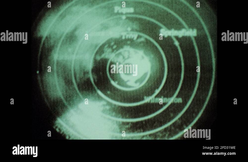 1970s: UNITED STATES: radar view and echo of tornado. Men at police ...
