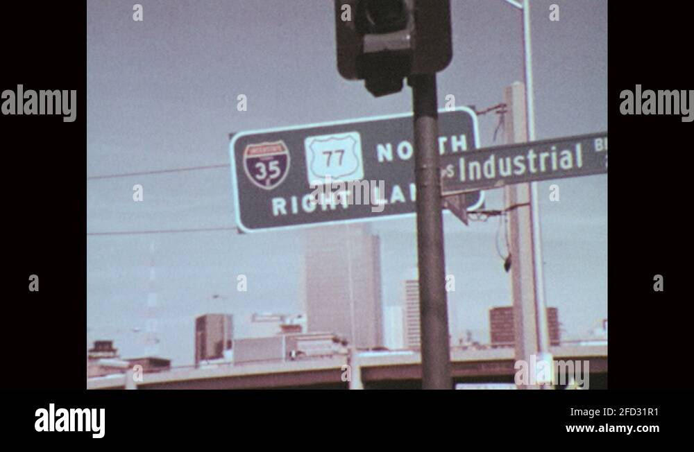 1970s: UNITED STATES: Traffic signs on road. View of road from moving ...