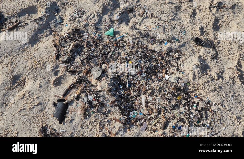 Environmental pollution. Sand beaches polluted with pieces of plastic ...