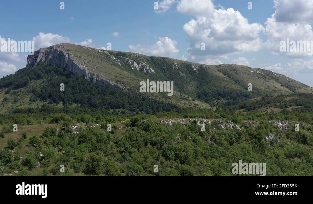 Flying forward to Stol mountain over the green hills and forest 4K ...