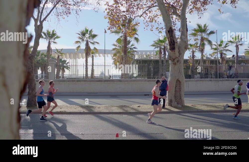Marathon runners in Malaga passing frame from left to right with ...