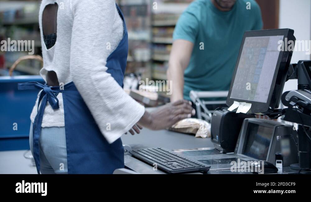 Back view of cashier scanning goods at checkout Stock Video Footage - Alamy