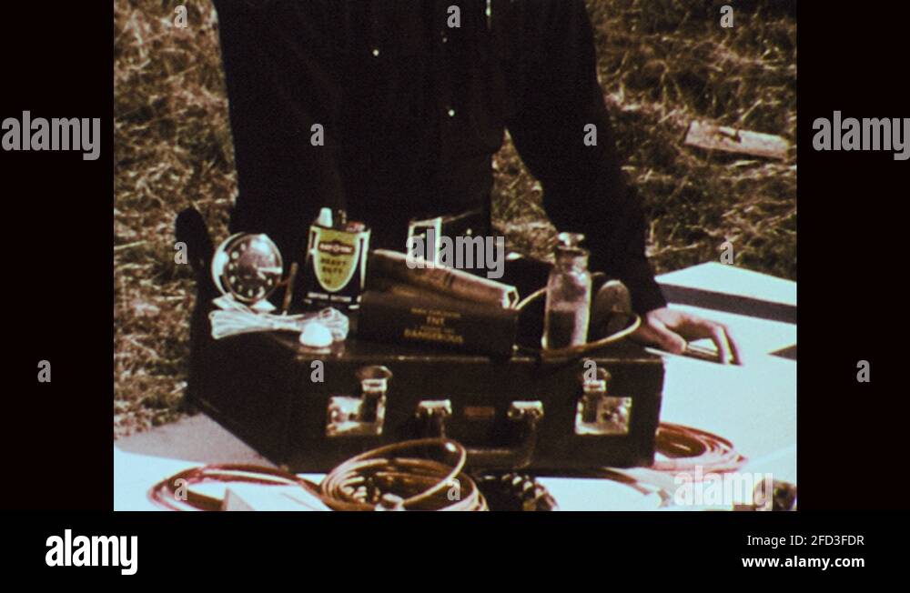 1970s: police officer standing behind table talking to crowd about ...