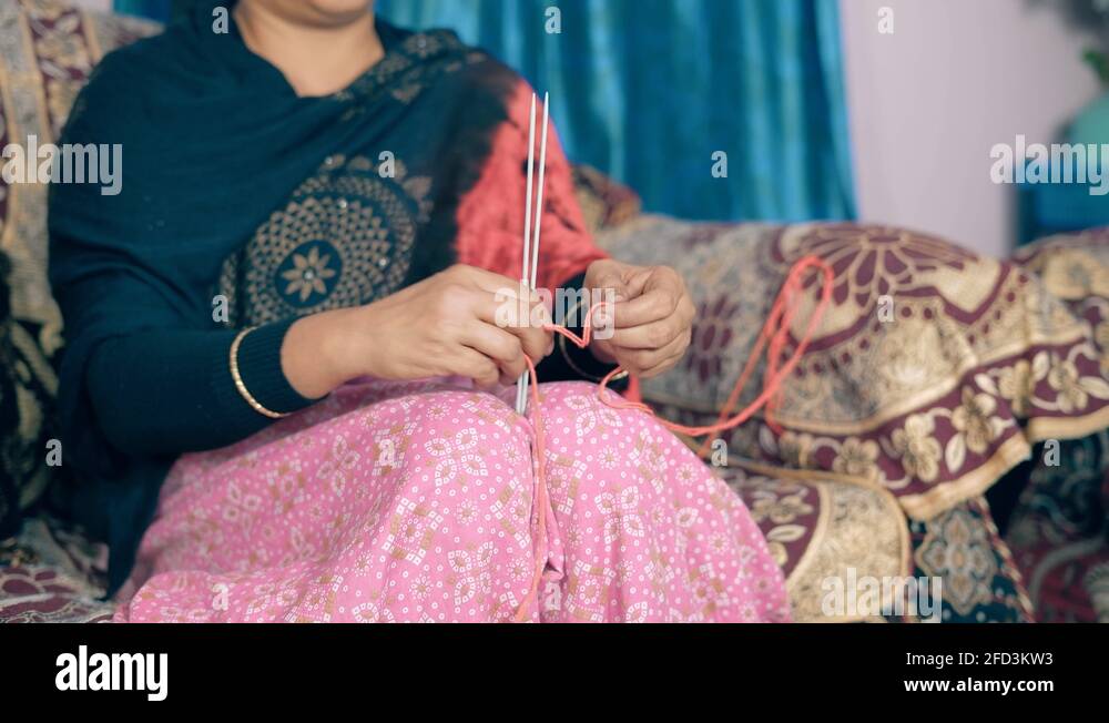 Traditional Indian woman tart knitting with two needle crafts and red ...