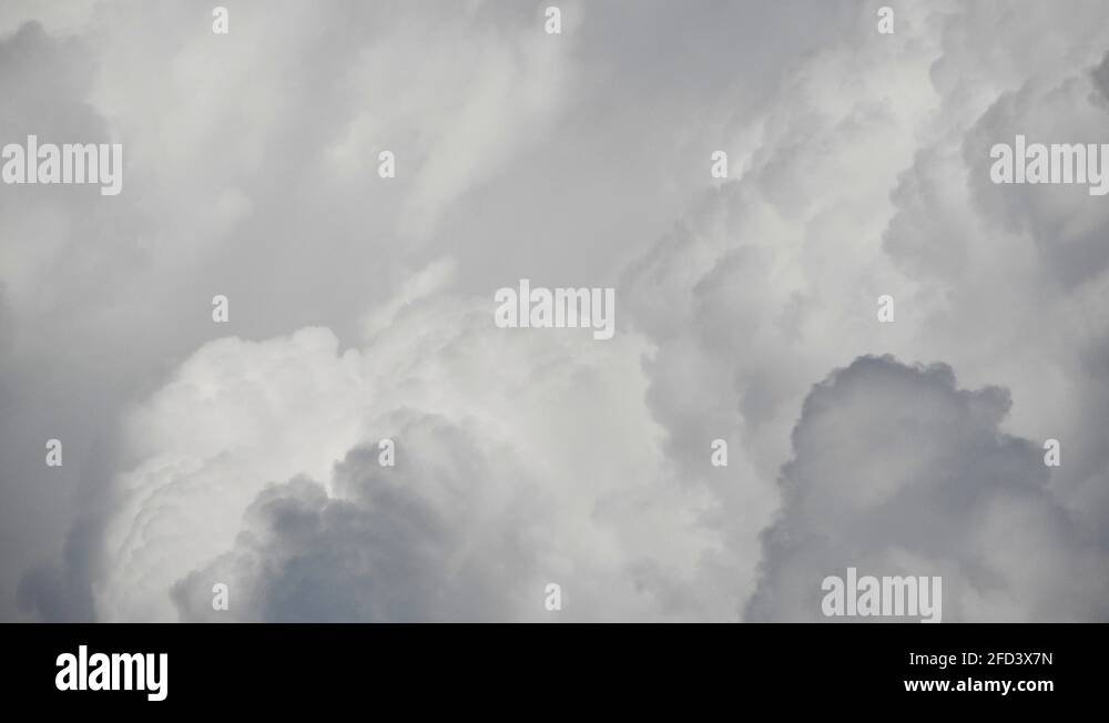 Massive Cumulonimbus clouds forming anding up high in the sky time ...