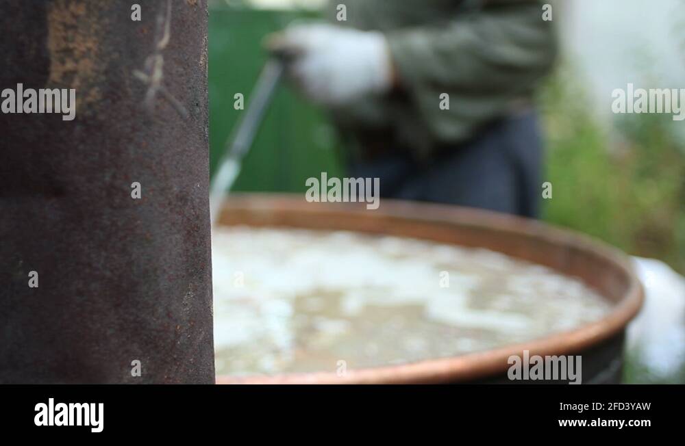 Traditional distillation of rakia (fermented fruit mixed with water and ...