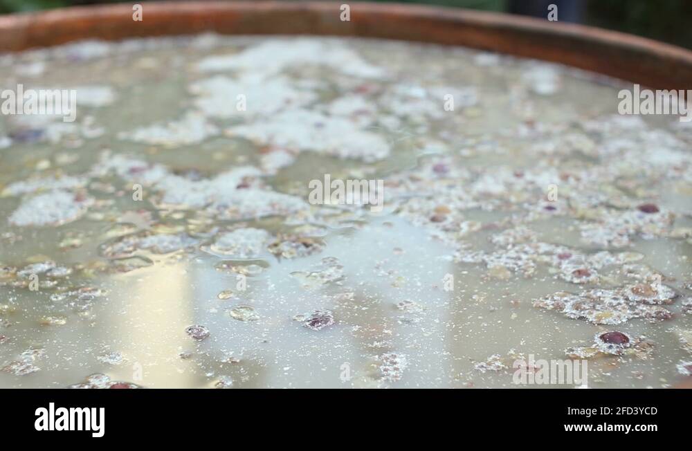 Traditional distillation of rakia (fermented fruit mixed with water and ...