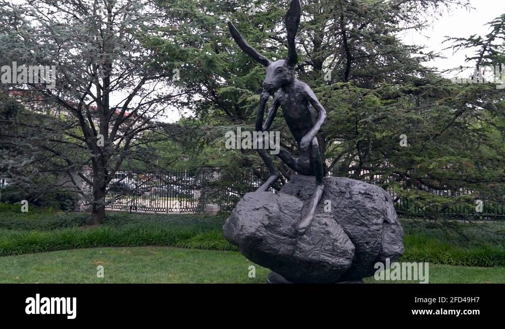 Statue sculpture of a metal rabbit bunny on a rock in a park Stock ...