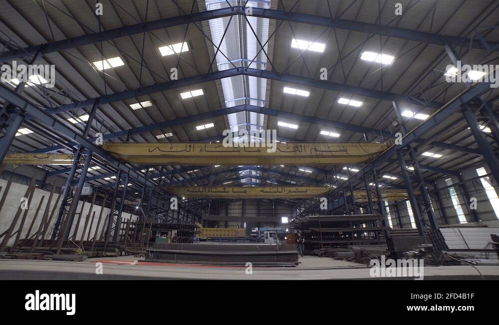 Bridge crane lift heavy metal bars inside steel production factory ...
