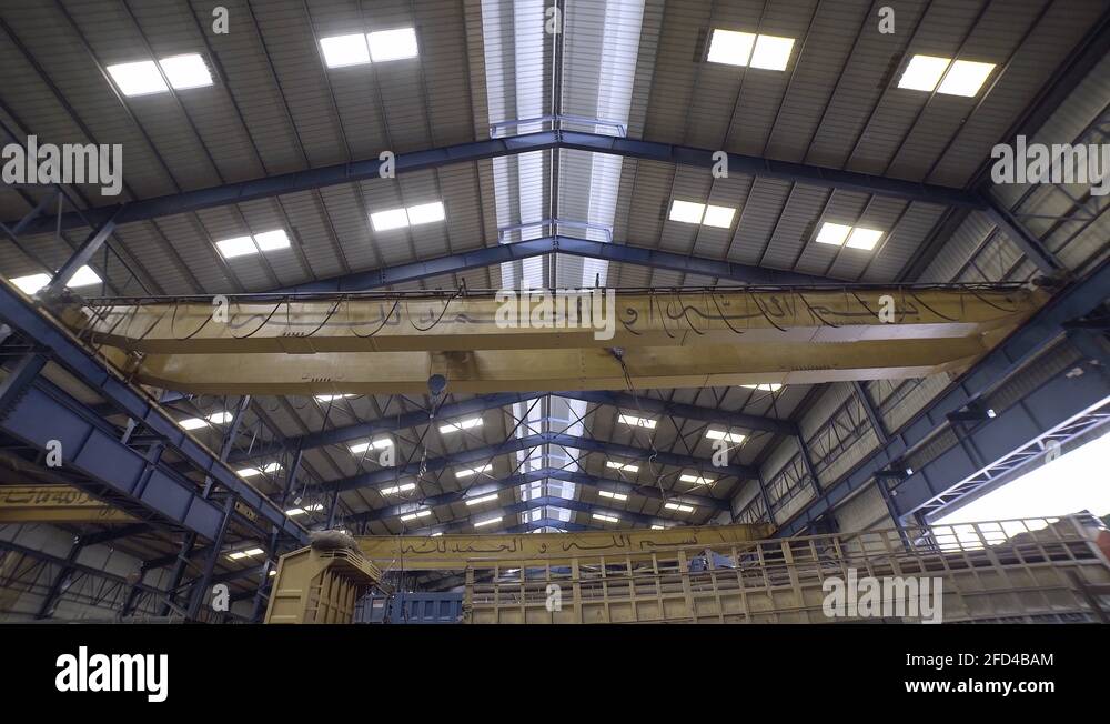 Bridge crane lift heavy metal bars inside steel production factory ...