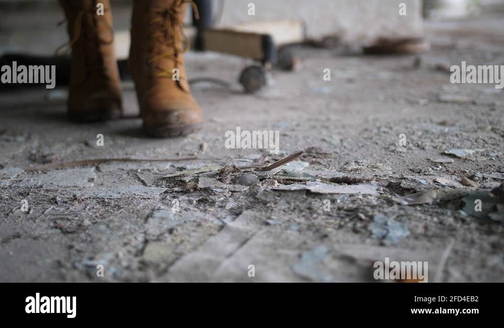A close up shot a woman with a pair of suede brown boots, kicking a ...