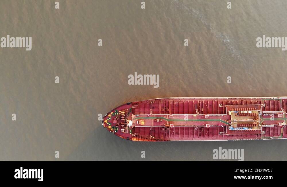 An aerial top down view on an empty container ship sailing down the ...