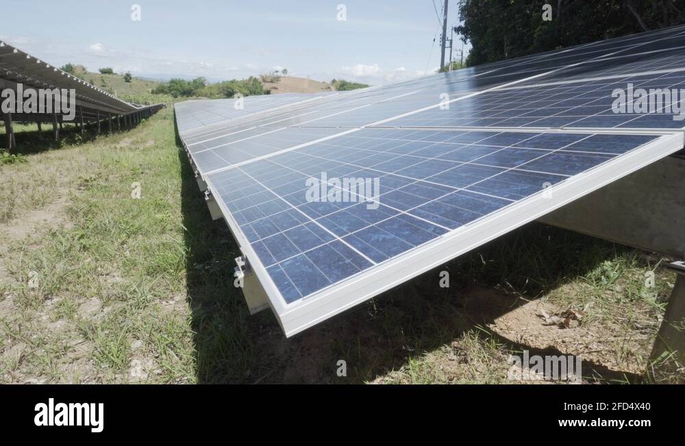 4K Crane elevation shot upwards of a big solar energy farm with lots of ...