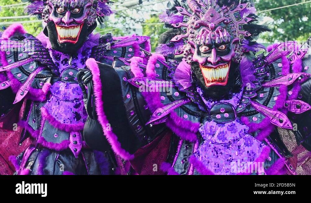 people in violet demon costumes dance at traditional dominican carnival ...