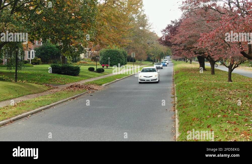 Cars driving in tranquil alley in suburban area of Lancaster Stock ...
