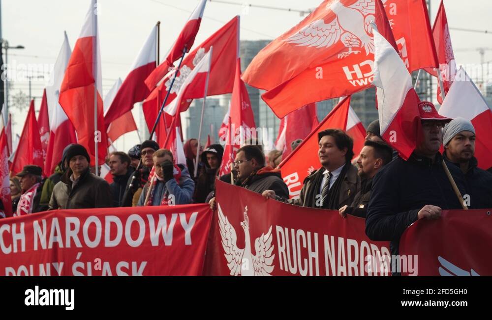 Exalted people with big red banners and Polish flags standing as a ...
