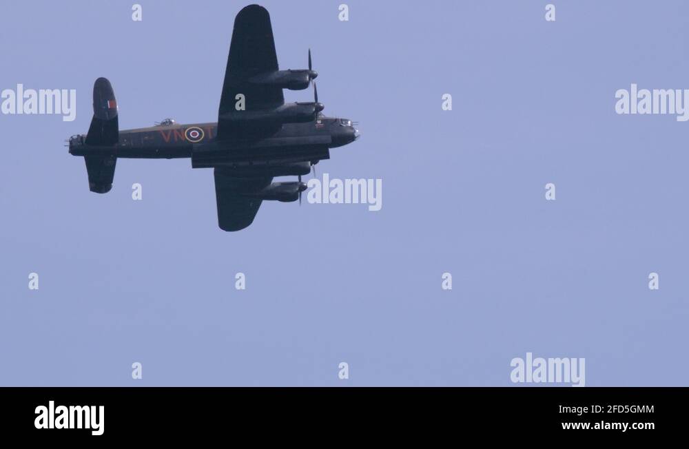 Avro Lancaster bomber plane flying in slow motion in the sky, Side view ...
