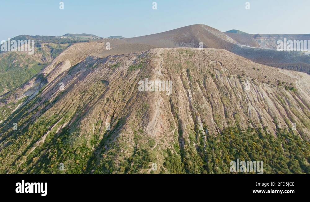 Drone circles around outside volcano crater rim, caldera slope fissures ...