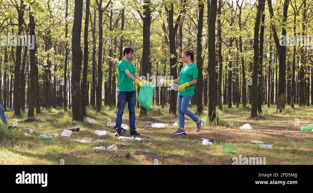 Group of people clean up garbage in suburban green area, selfless help ...