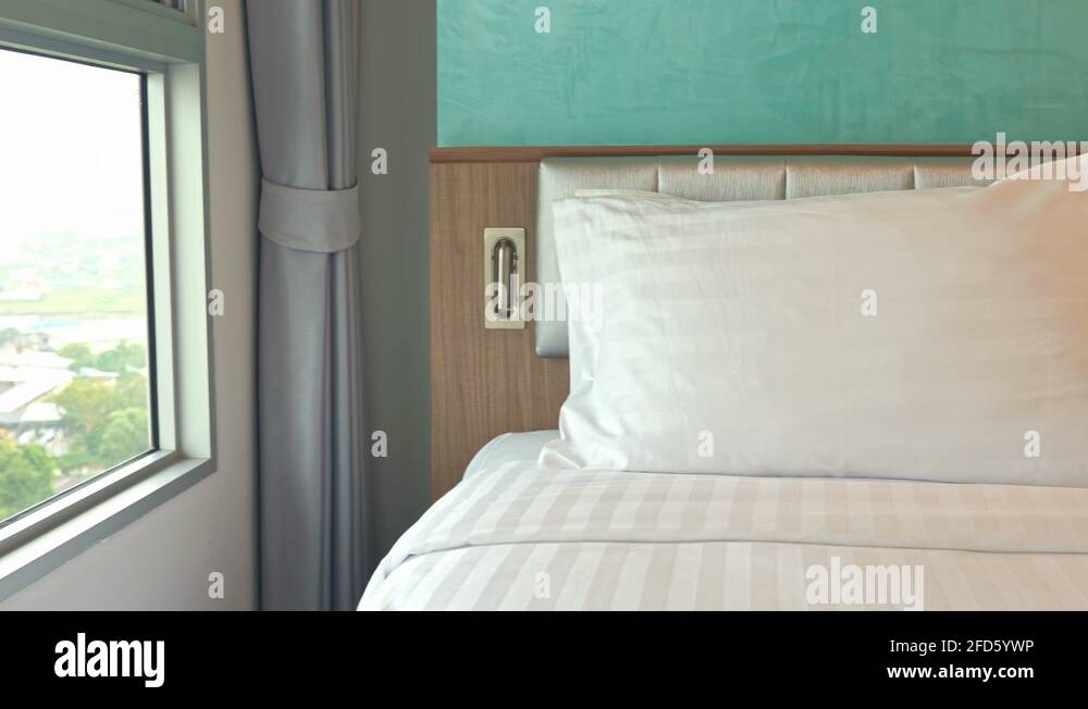 Pan from a window with an ocean view to a hotel bed Stock Video Footage ...