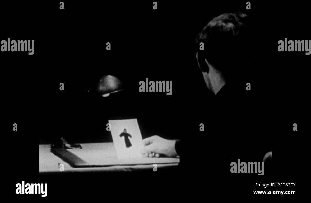 1950s: Man sits at desk holding picture. Ghost appears Stock Video ...