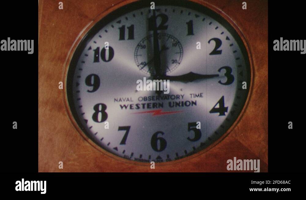 1950s: Clock. Man looking at clock. Second hand on clock moves. Man ...