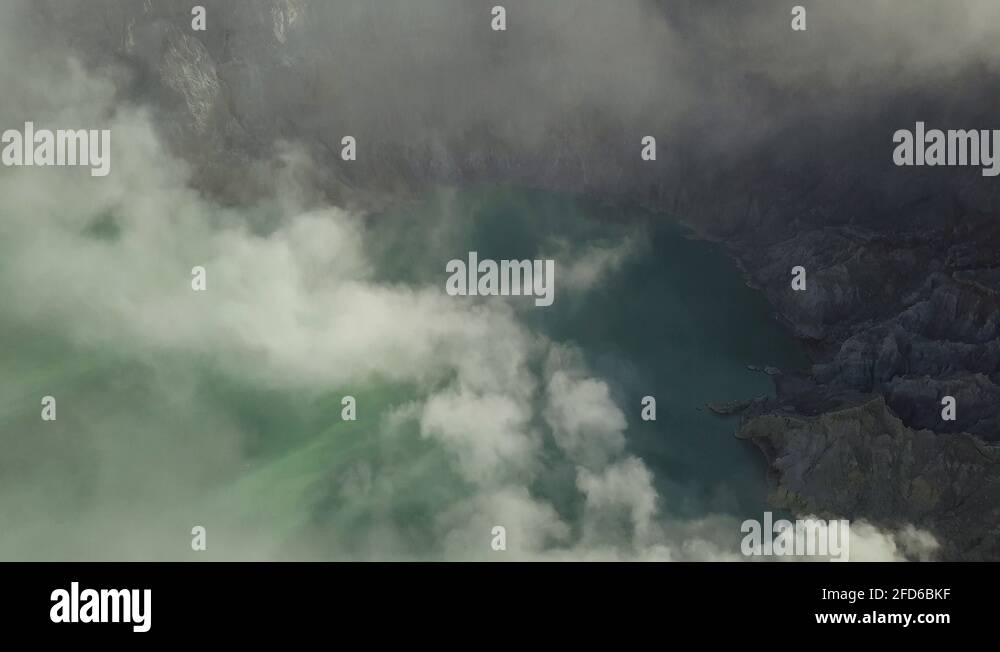 Aerial Pan Down of Acidic Lake With Smoke Inside a Volcano Stock Video ...