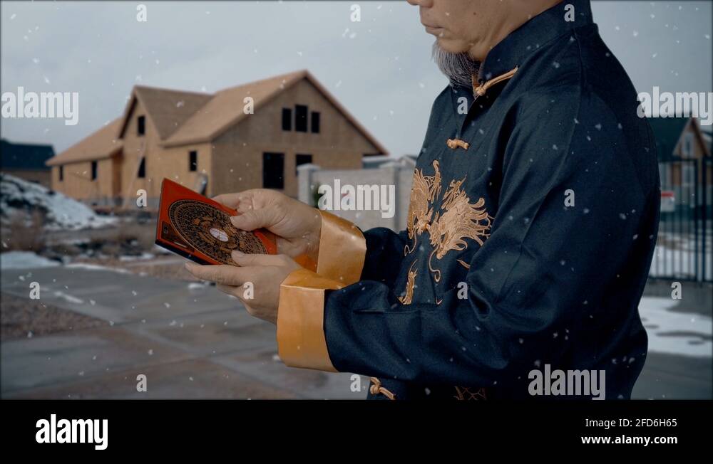 A Feng Shui master checks the Lo-Pan compass and uses energy forces to ...