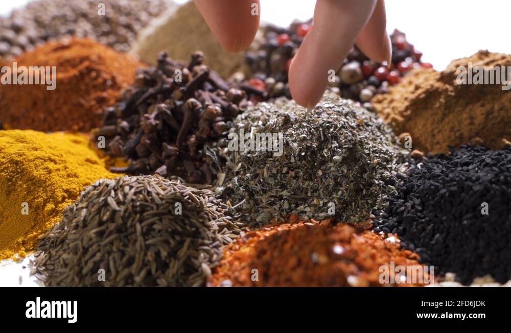 Human hand holds and press a pinch of a fragrant herbs by a hand over ...