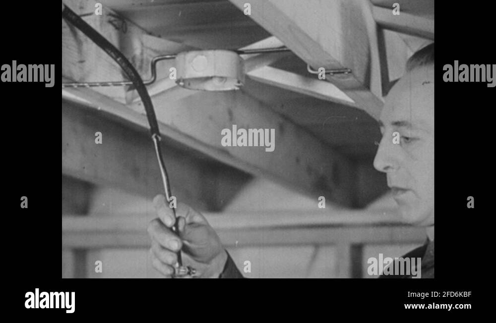 1940s: Man attaches part to electrical cable, runs cable through outlet ...