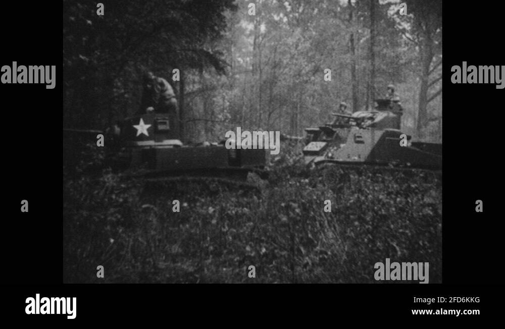 1940s: UNITED STATES: tanks in trees. Soldiers load supplies Stock ...