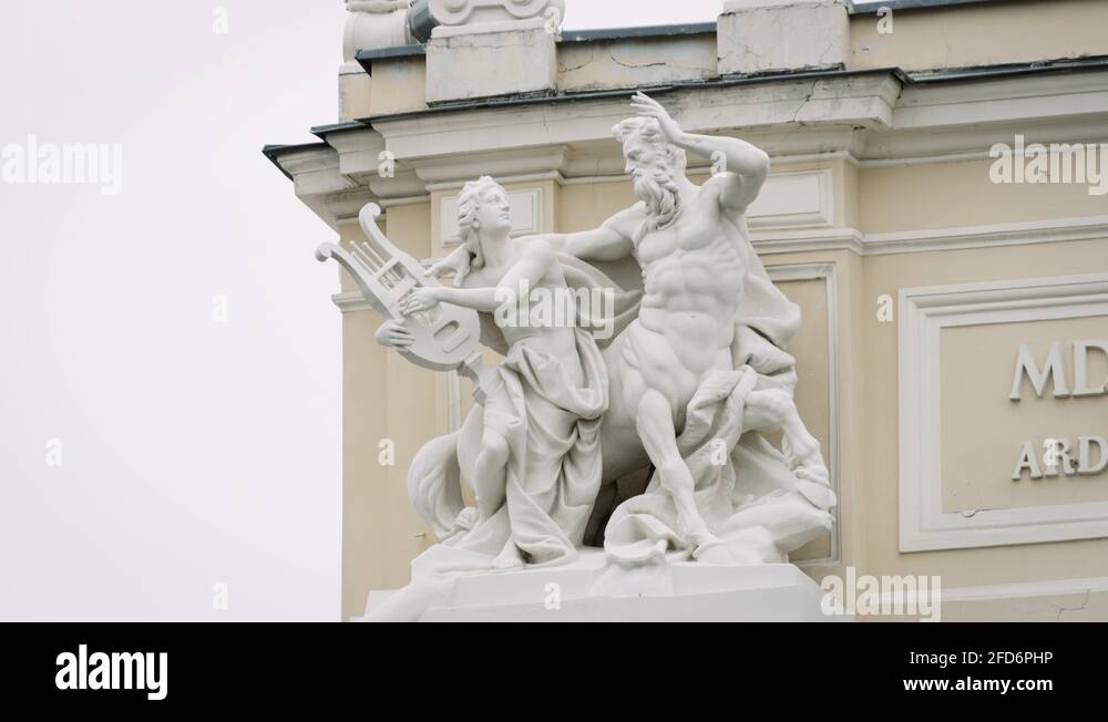 Centaur and musician statue depicting dancing on ornate theater rooftop ...