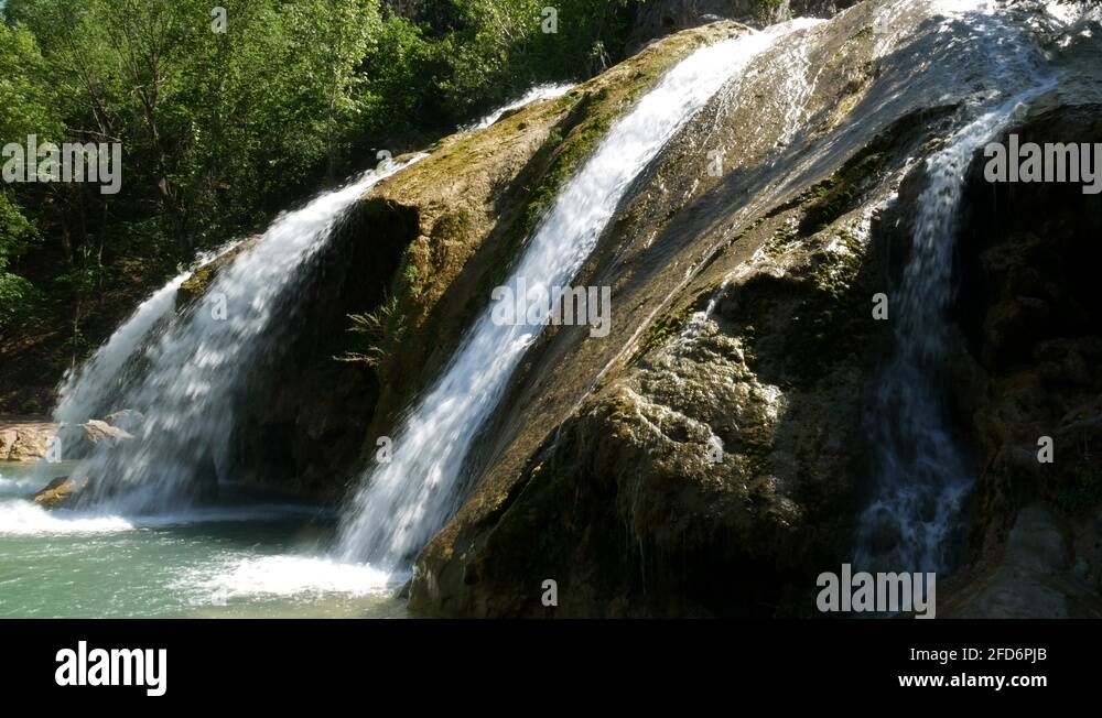 Close up, side view of water cascading down a waterfalls Stock Video ...