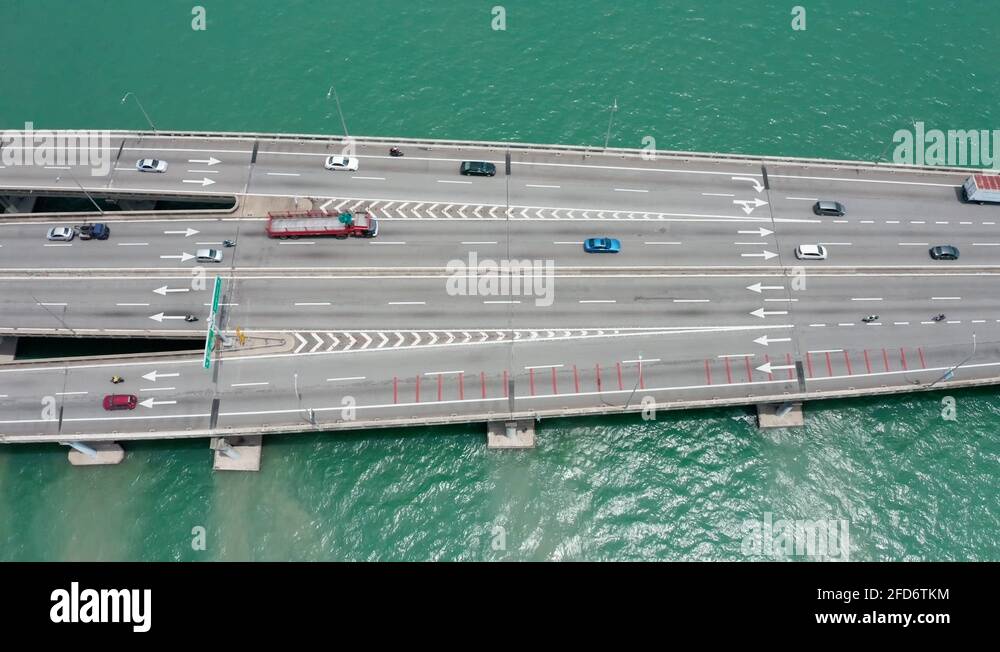 Penang Bridge Malaysia aerial side view with traffic lanes merging in ...