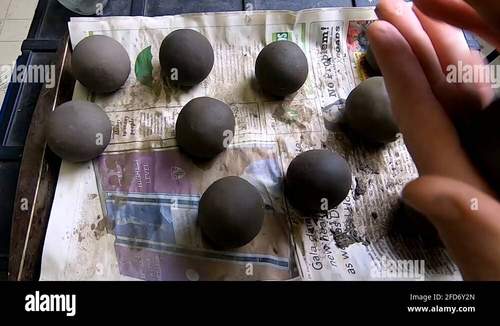 Making Dorodango. Japanese art of sculpting a sphere out of clayr Stock ...