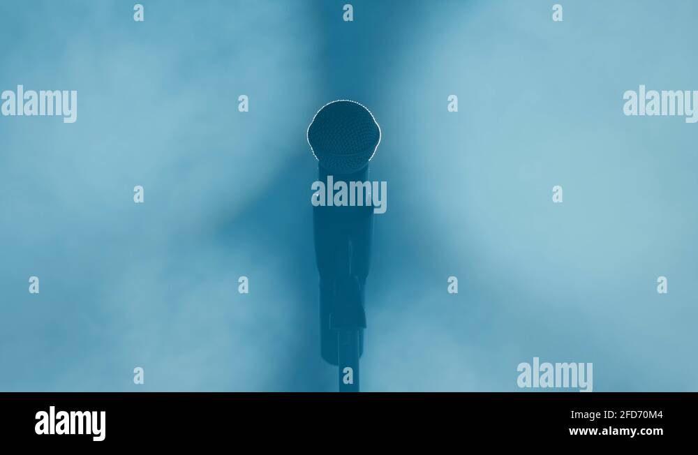Microphone on stage with blue smoke haze and Abstract lighting. Low ...