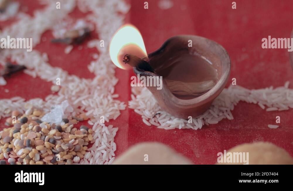 Close-up of a Diya (clay oil lamp) in a Hindu traditional wedding ...