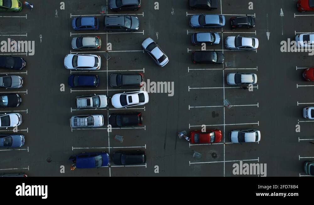 Drone footage cars parking at congested parking lots. people walking ...
